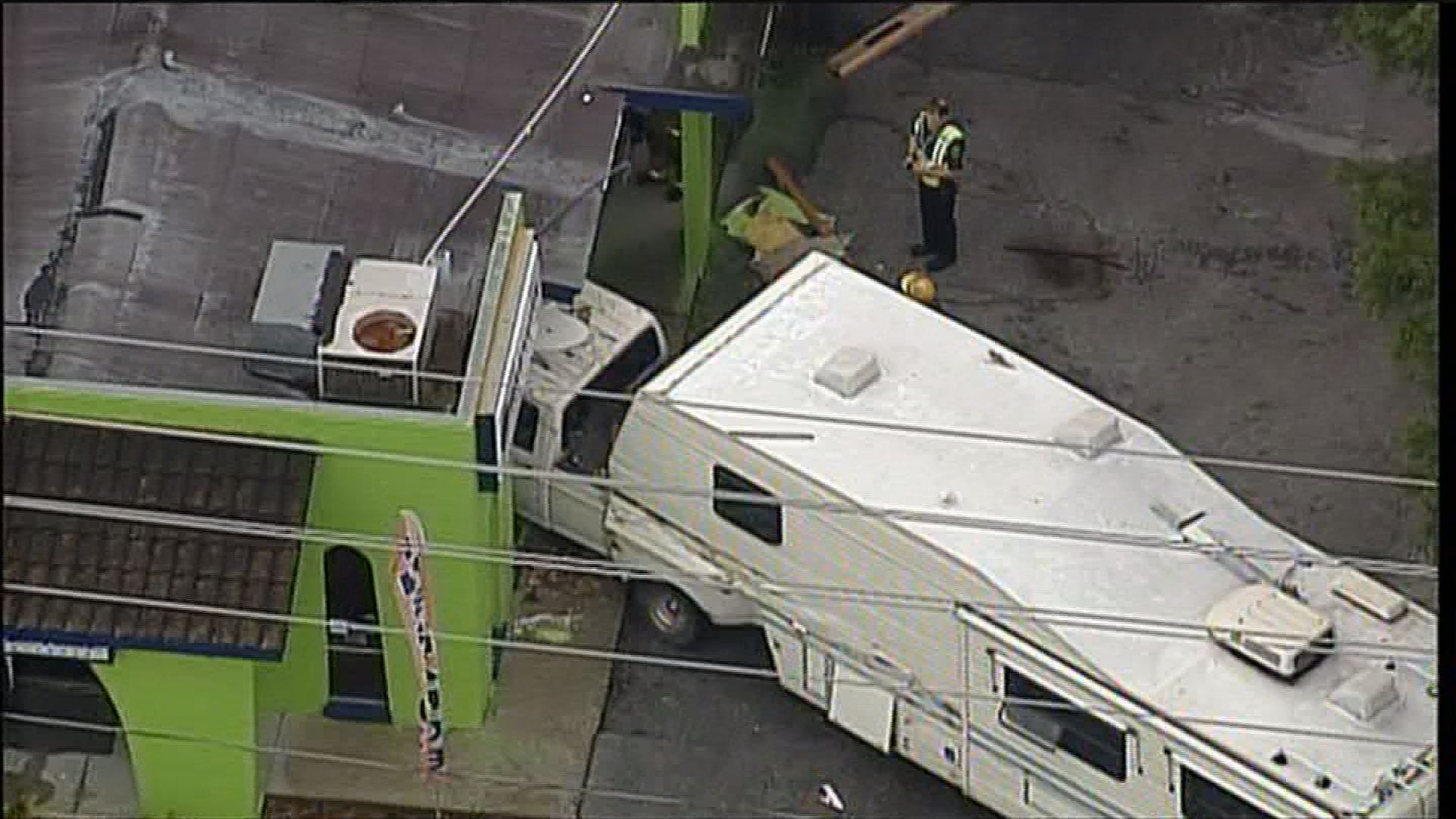 Trailer takes out car, crashes into building | wtsp.com